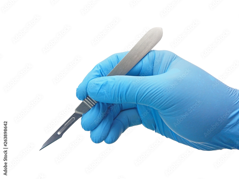 Hand of surgeon in blue medical glove holding a scalpel with blade ...