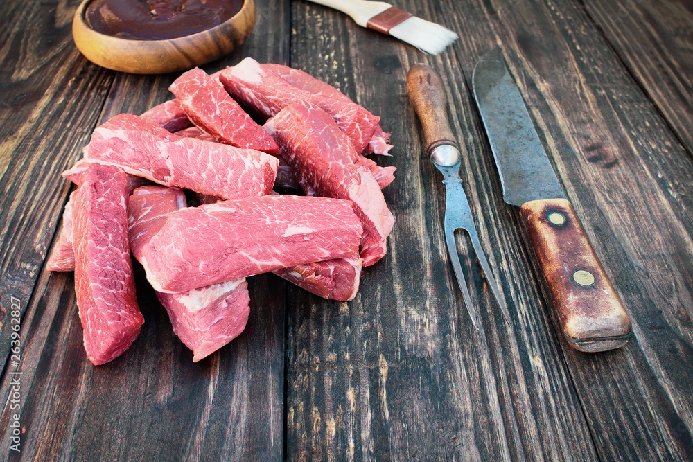 Uncooked raw boneless beef ribs with vintage meat fork and butcher's ...