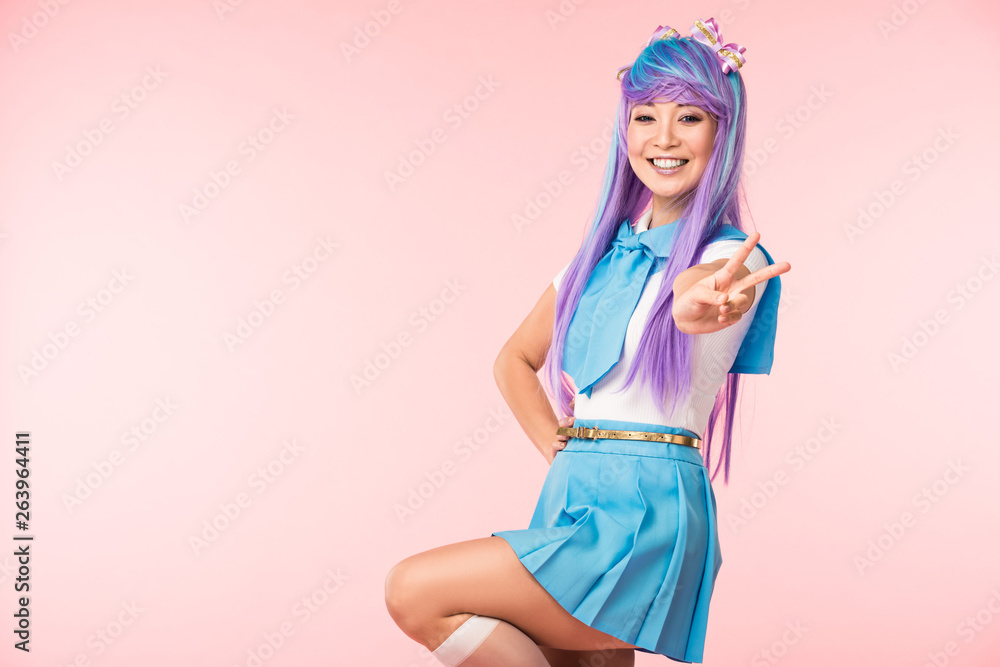 Foto de Happy asian anime girl standing on one leg and showing peace ...