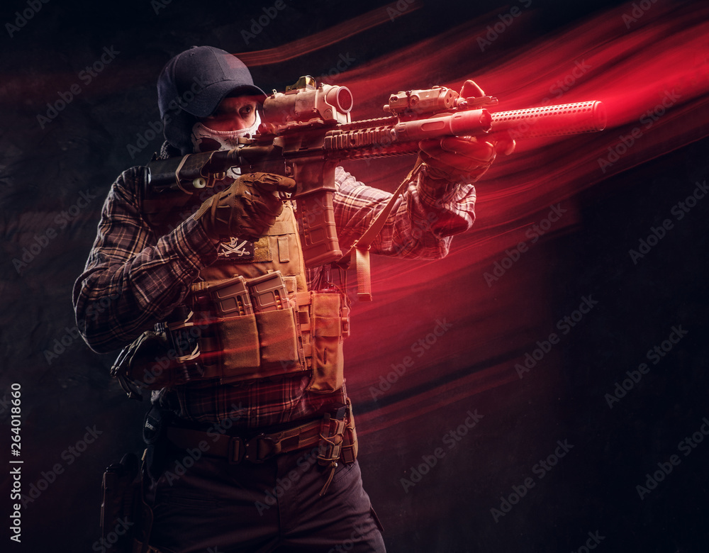 Special forces soldier wearing a checkered shirt and protective ...