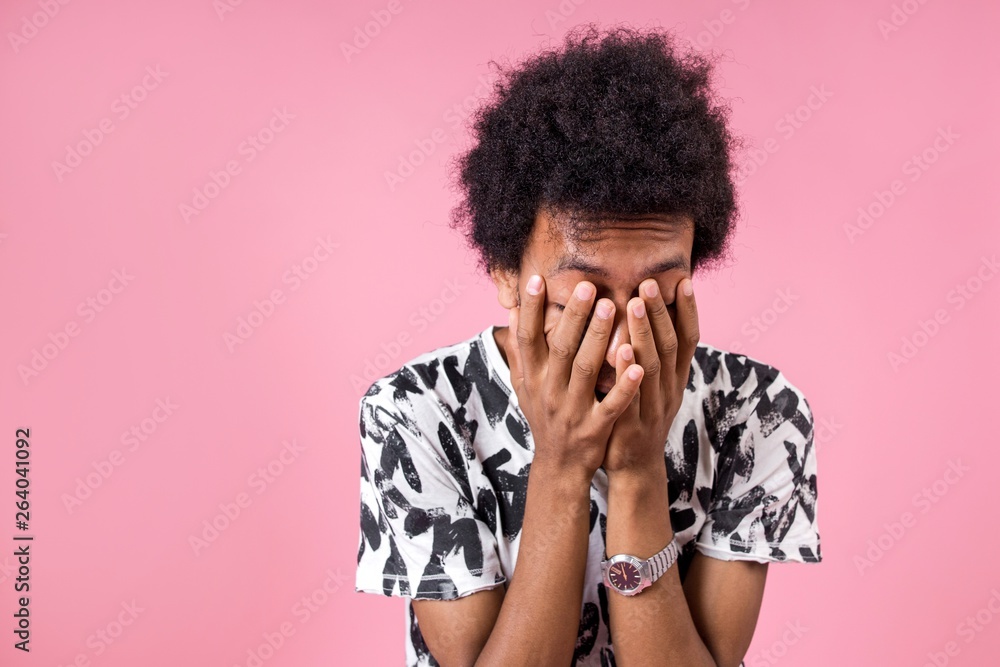 African man crying holding hands to face Stock Photo | Adobe Stock