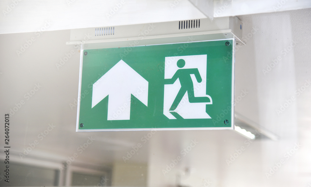 fire exit sign emergency green on wall corporate office building Stock ...