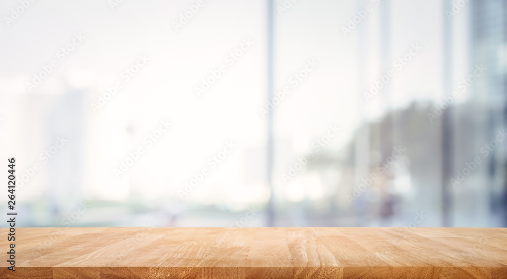 Wood table top on blur window glass,wall background with city view.For ...