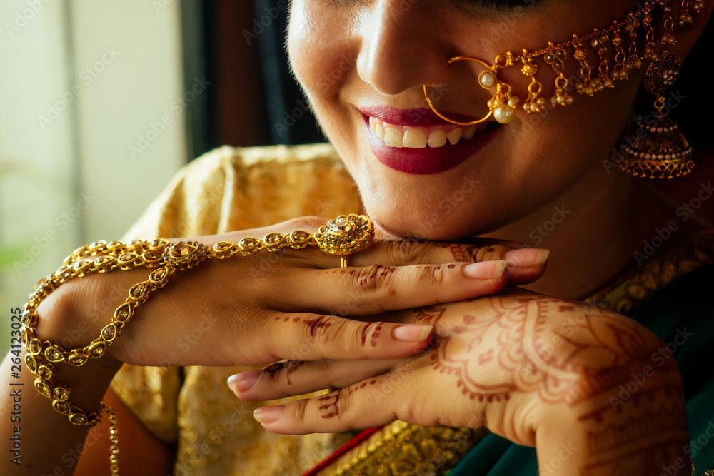 portrait indian beautiful female in golden rich jewelery and tradition saree face closeup ...