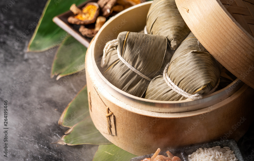Zongzi, delicious fresh hot steamed rice dumplings in steamer. Close up ...