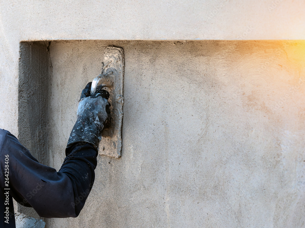 plastering tool to set the surface to smooth the plaster wall Stock ...