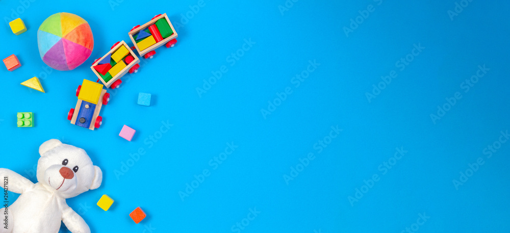 Baby kids toys background. White teddy bear, wooden train, colorful ...