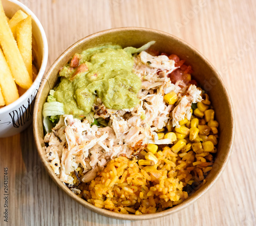 Portuguese pulled chicken bowl with spicy rice and potato fries. Stock ...