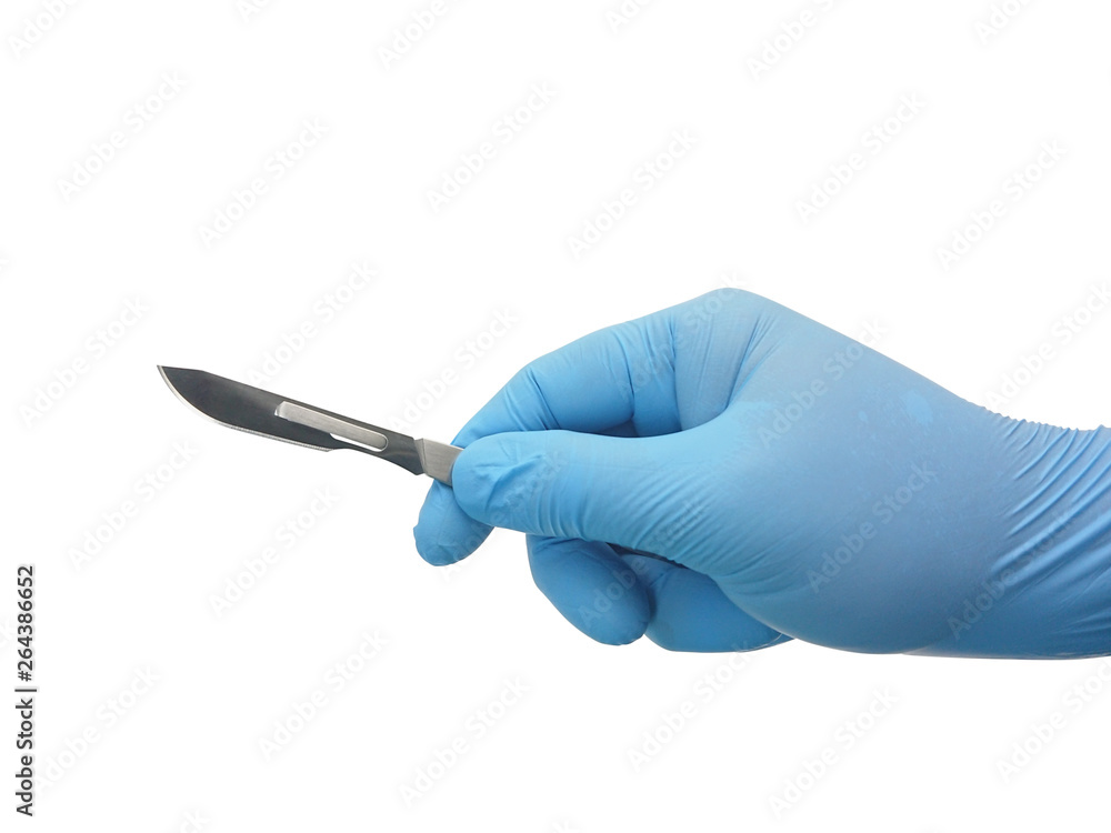 Hand of surgeon in blue medical glove holding a scalpel with blade ...