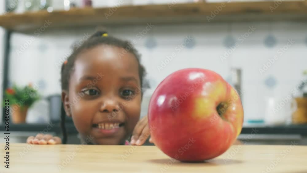 Little girl taking apple Stock Video | Adobe Stock