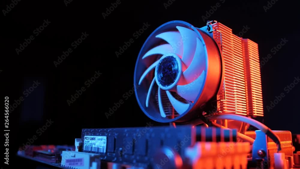 rotating processor CPU fan installed on the motherboard on a black ...