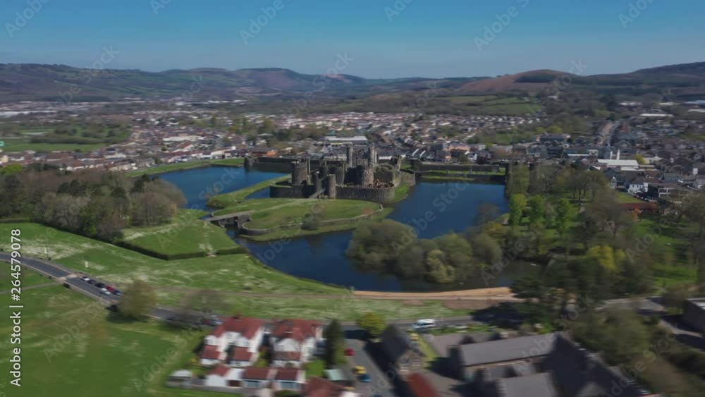 Wide aerial orbit hyperlapse of Caerphilly Castle north of Cardiff ...