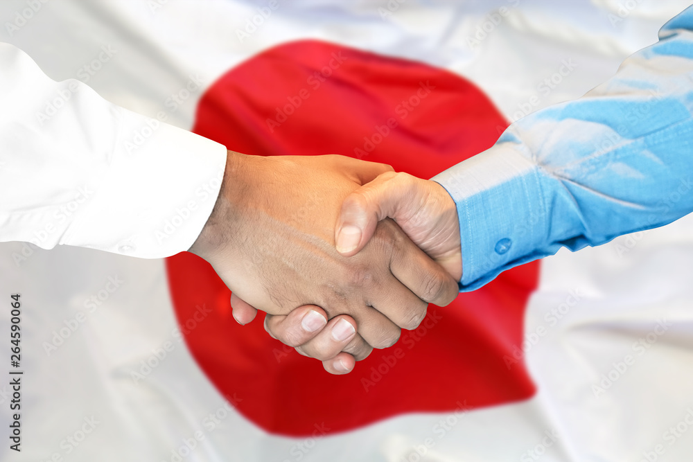 Business handshake on Japan flag background. Men shaking hands and ...