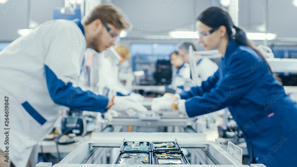 Shot of an Electronics Factory Workers Assembling Circuit Boards by ...