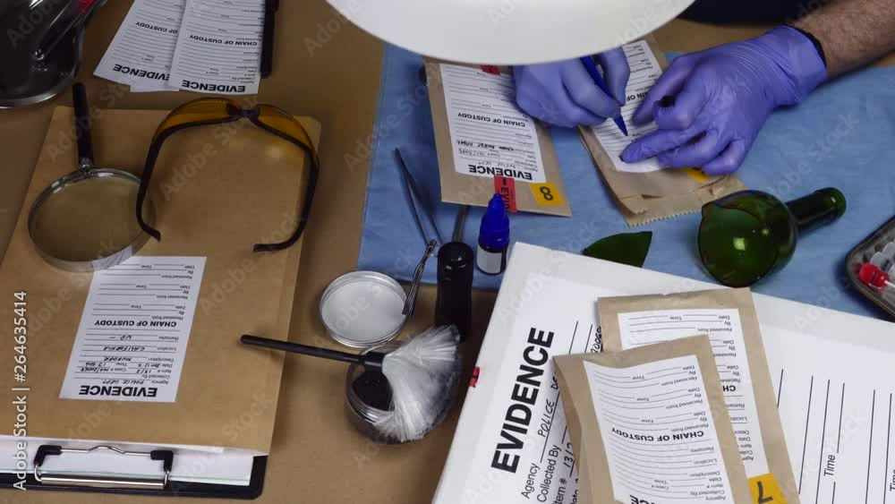 Police expert filled form with evidence bag in crime lab Stock ビデオ ...