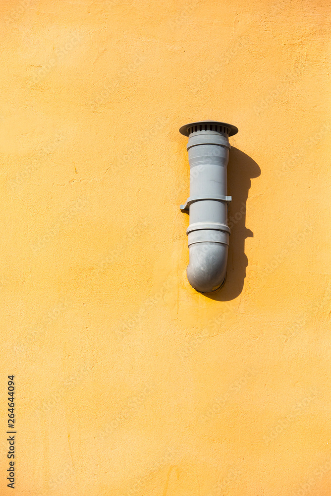Plastic vent pipe on the orange wall. Air ventilation pipe mounted on ...