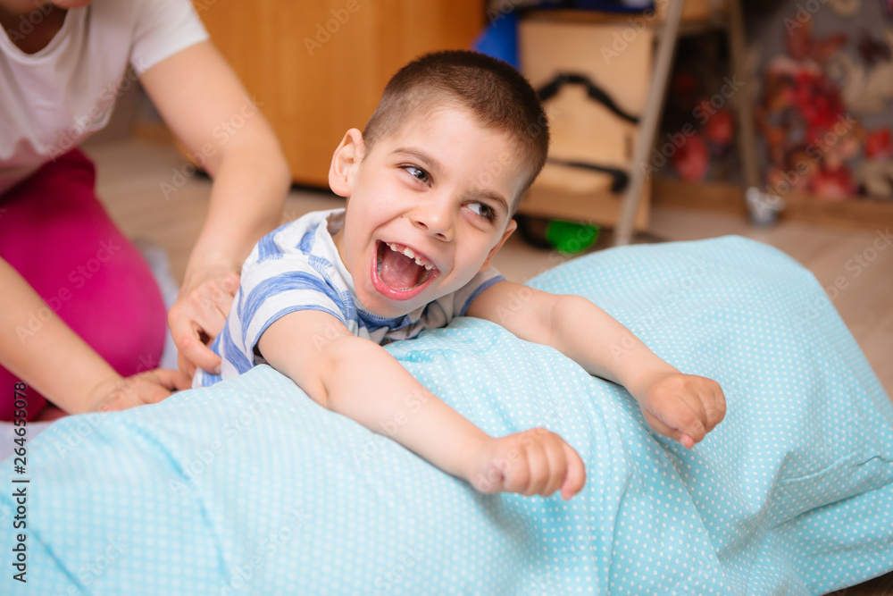 little kid with cerebral palsy has musculoskeletal therapy by doing ...