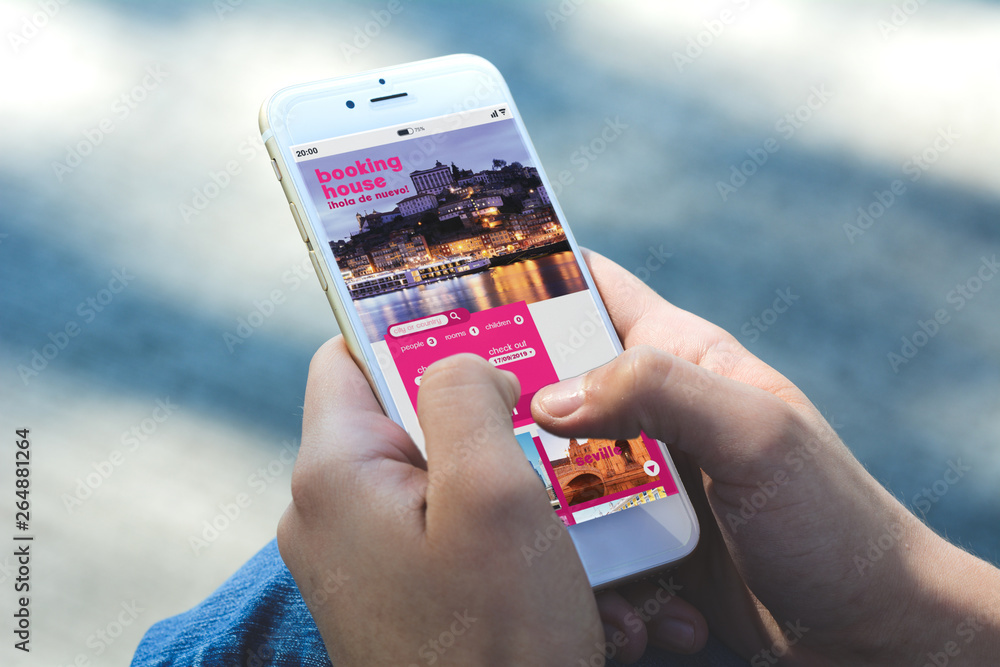 Woman with smartphone booking a hotel on application Stock Photo ...