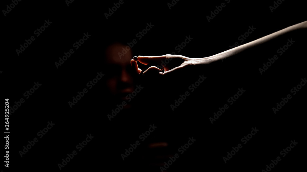 Drug dealer hand offering pill to addicted person in darkness, death ...