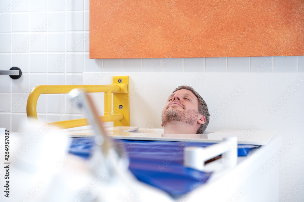 Man, a woman in her mid thirties enjoys a water / bath or physical ...