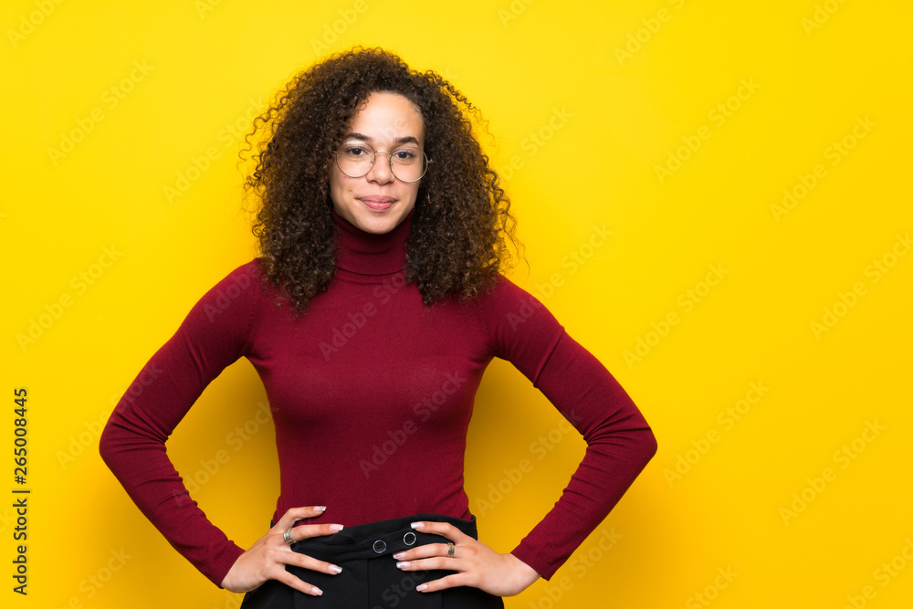 Dominican woman with turtleneck sweater posing with arms at hip and ...