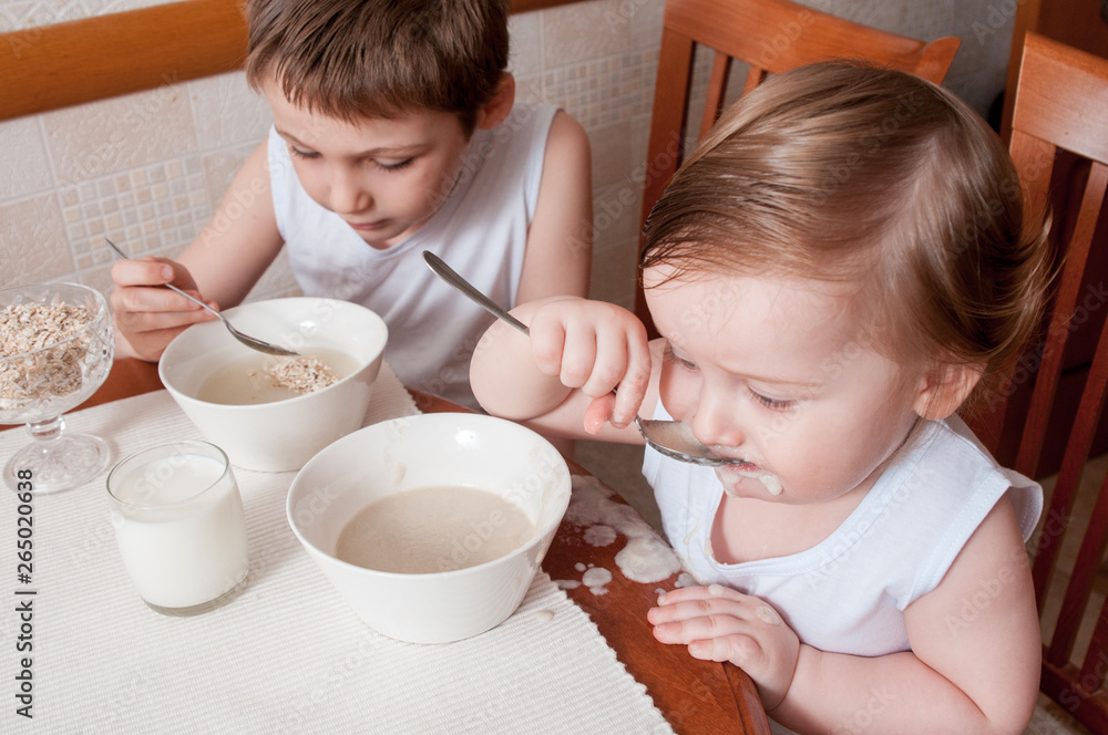 Family Having Breakfast In Kitchen .happy children, boy and girl play ...