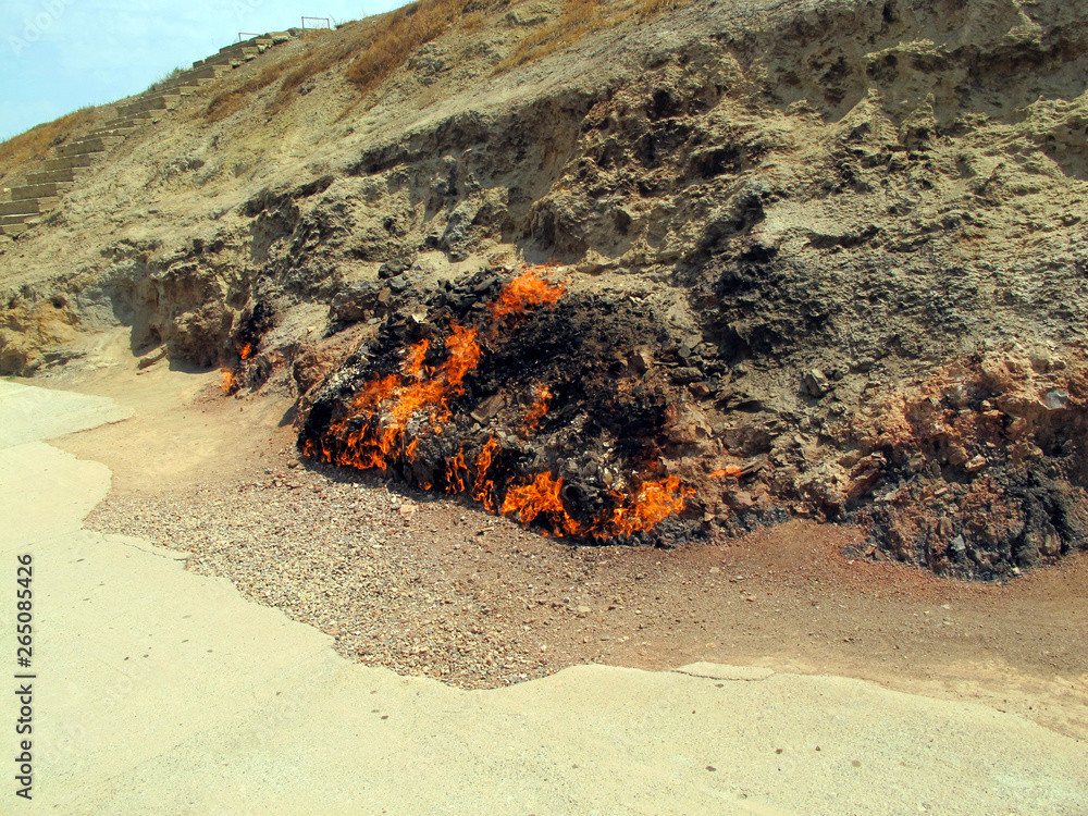 Oil deposit. The earth burns from an oil spill. Oil is seeping out of ...