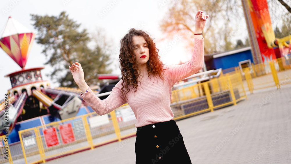Beautiful exited smiling woman having fun and dancing at amusement park ...