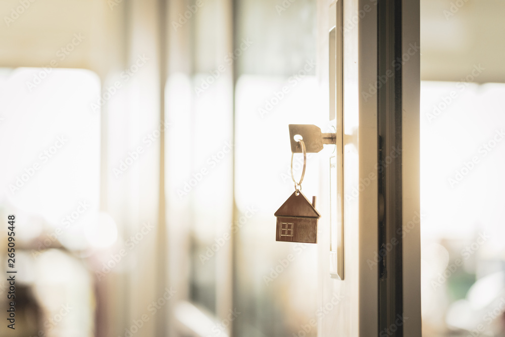 House model and key in house door. Real estate agent offer house ...