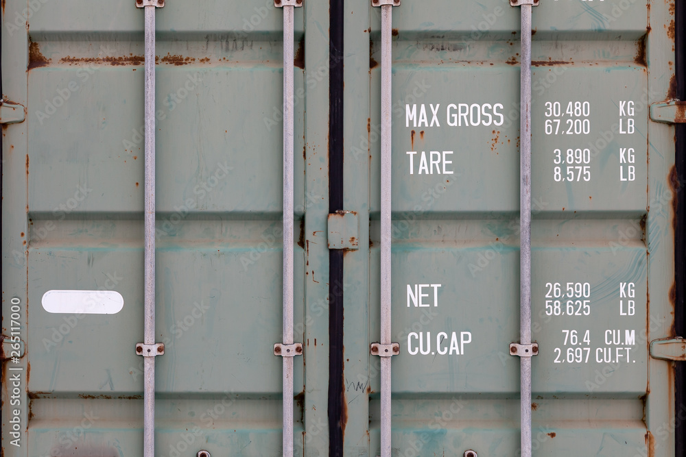The doors of a large old container are painted in close-up in green ...