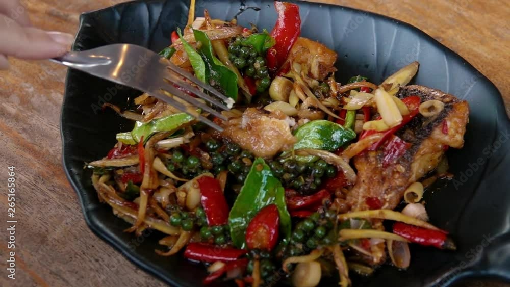 Eating Fried Fish with Lemongrass and Chili. Traditional Food of ...