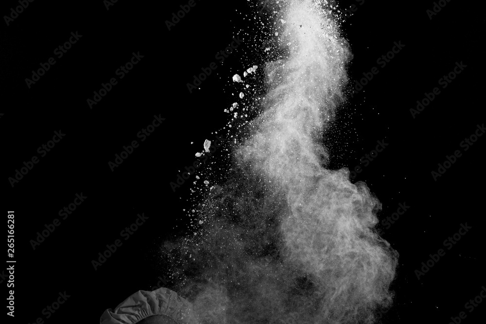 Bizarre forms of white powder explosion cloud against black background ...