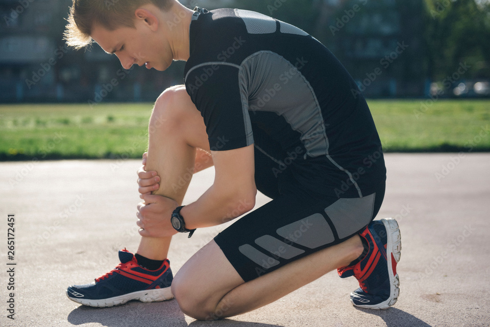 pain in the leg while running in the stadium. Trauma of the leg while ...