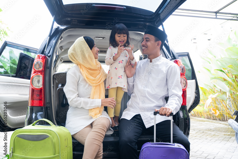 happy asian muslim family with kid sitting in the car trunk with ...