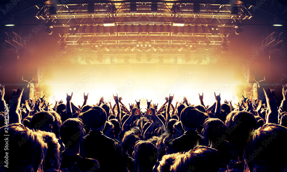 Raised hands in front of a concert stage for a festive crowd Stock ...