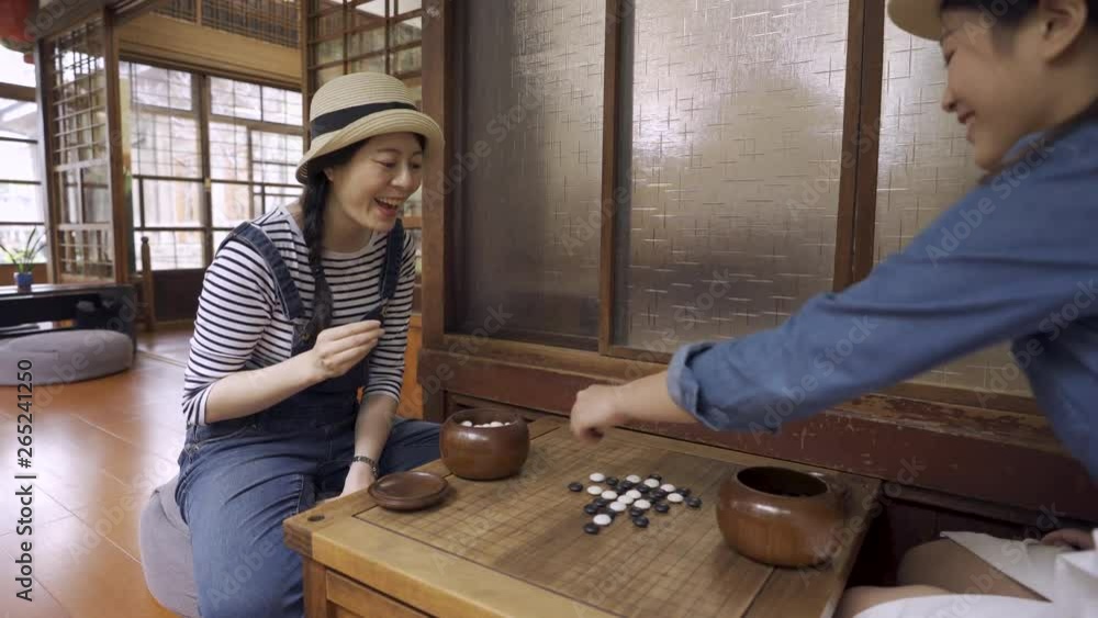 Go ancient board game. young japanese girl playing igo chess on wooden ...