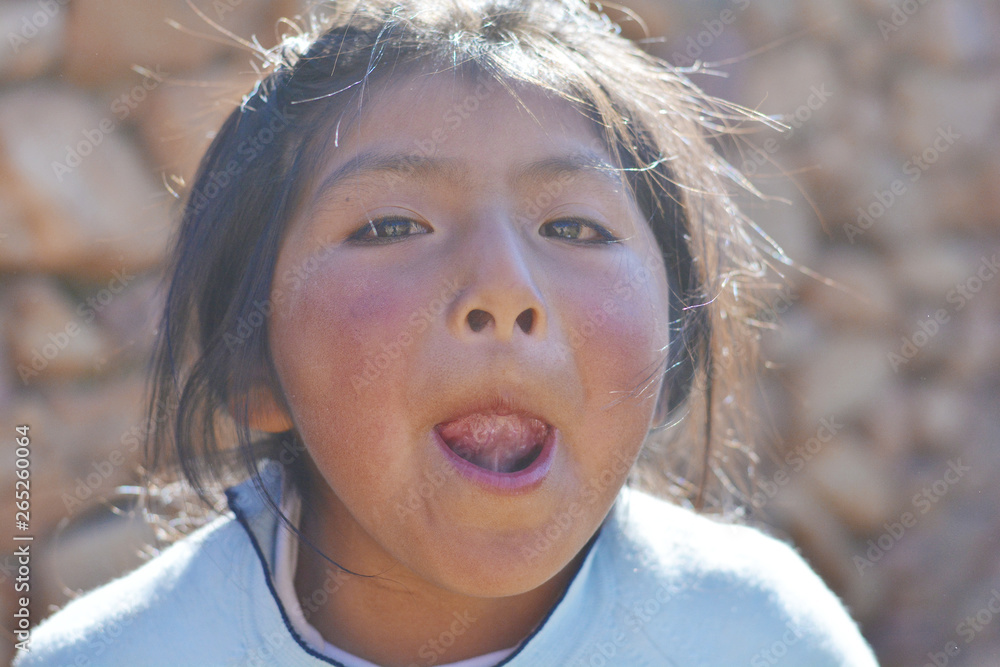 Little native american girl doing exercises for correct pronunciation ...