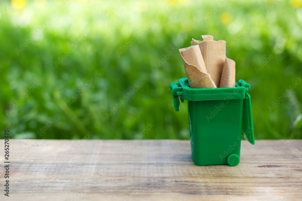 separating paper in green container to save natural resources foto de ...
