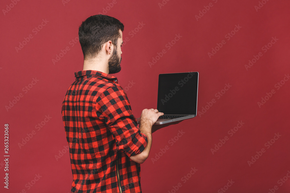 Back view of a man who is standing with a laptop. Rear view people ...