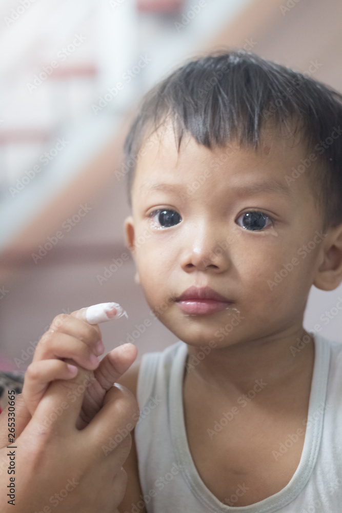 child was wound in the finger crying. Stock Photo | Adobe Stock