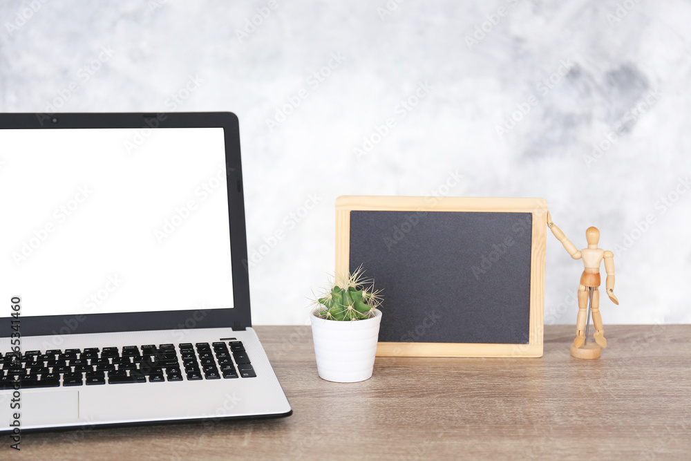Laptop on table, on blackboard background,blank screen Stock Photo ...