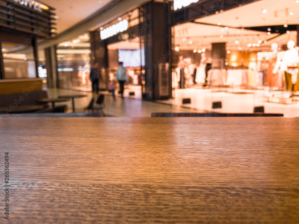 Blurred image wood table and abstract department store shopping mall ...