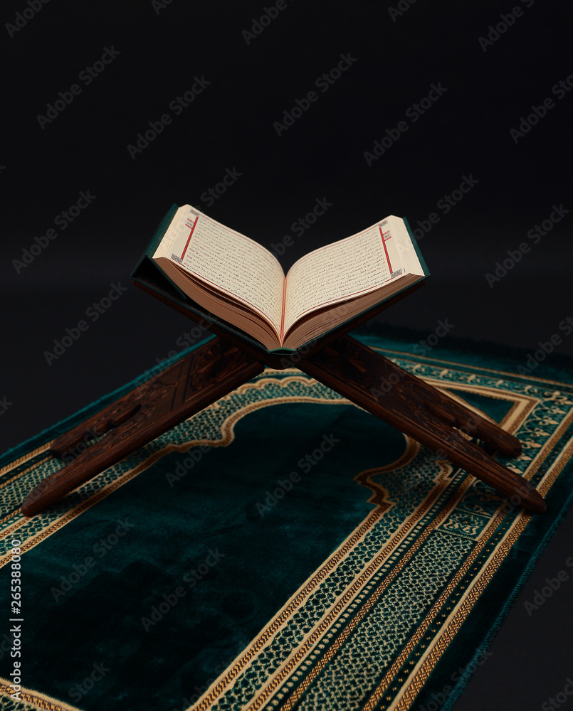 Islamic Holy Book Quran on wood carving rahle with rosary beads and ...