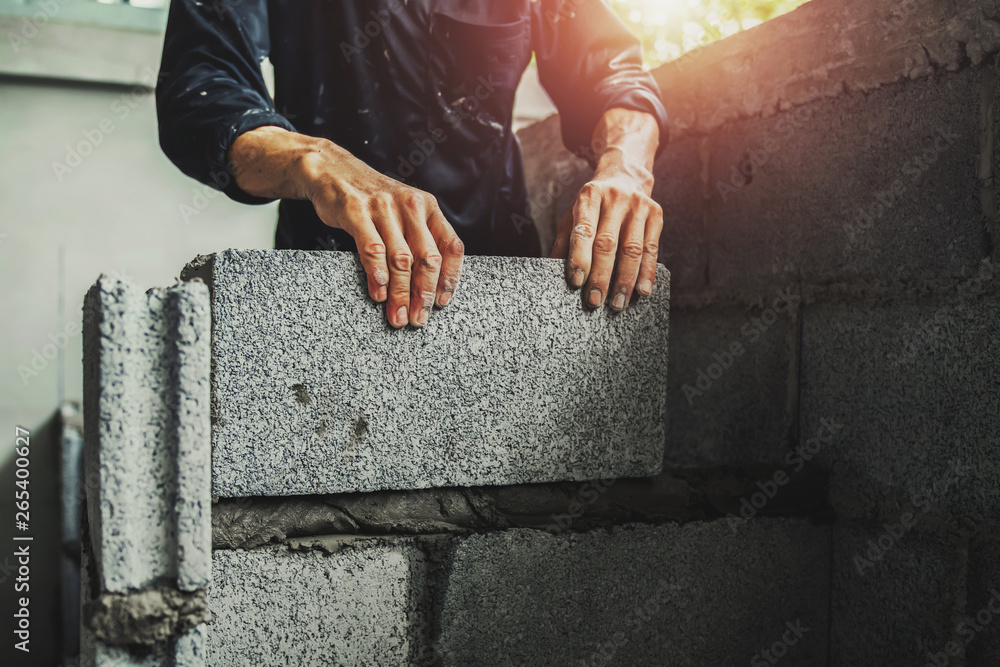 Worker building wall bricks with cement Stock Photo | Adobe Stock