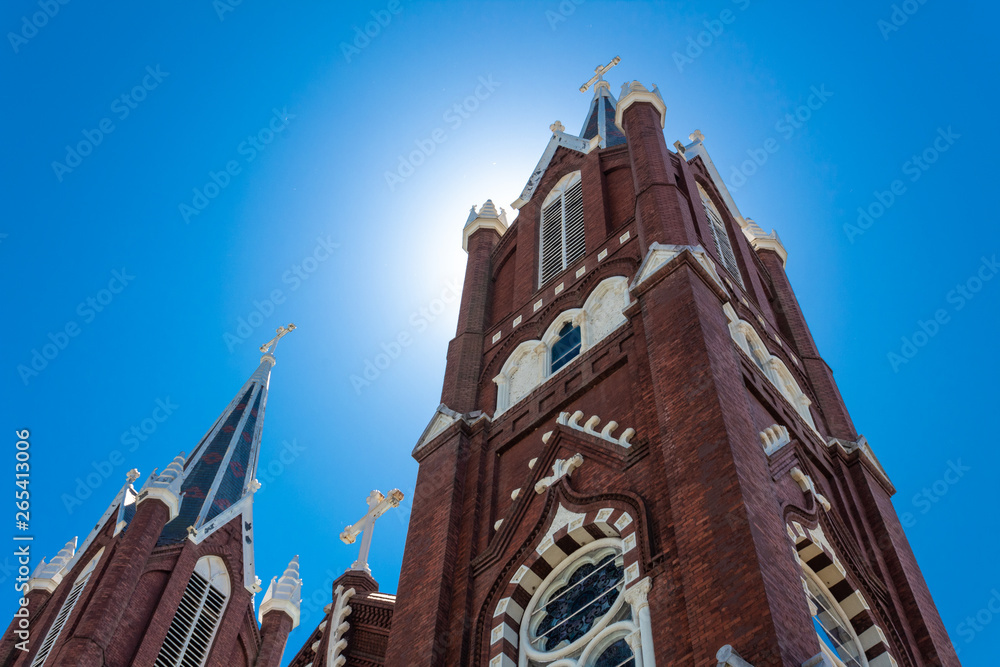 Sunlight glow from behind a beautiful Gothic Revival church, three ...