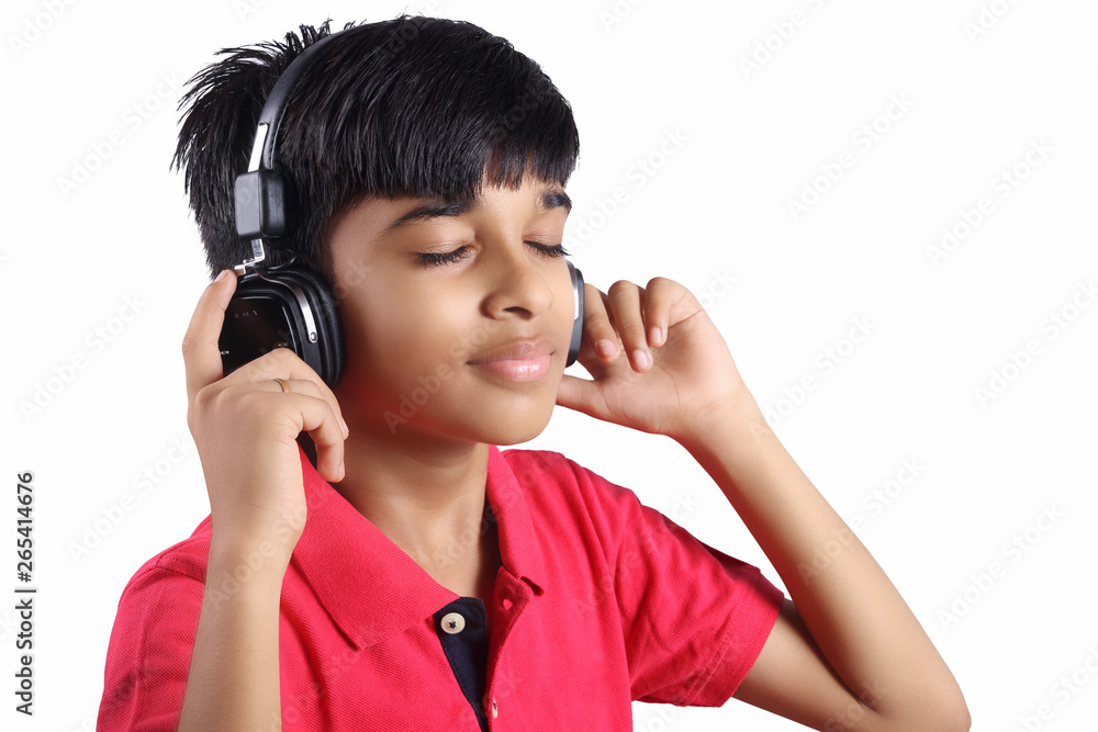 Indian young boy listen music with headphone Stock Photo | Adobe Stock