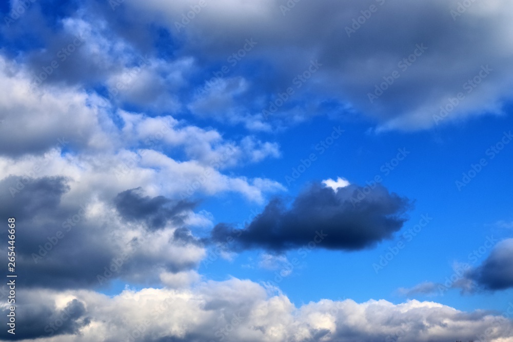 Beautiful mixed cloud formation with white and grey cumulus clouds in ...