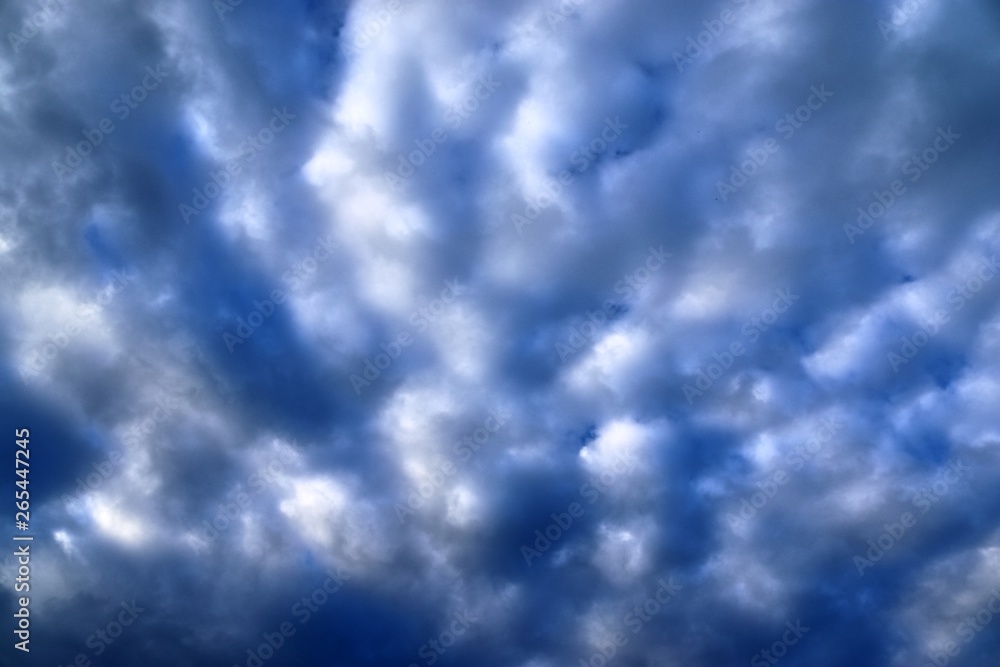 Beautiful mixed cloud formation with white and grey cumulus clouds in ...