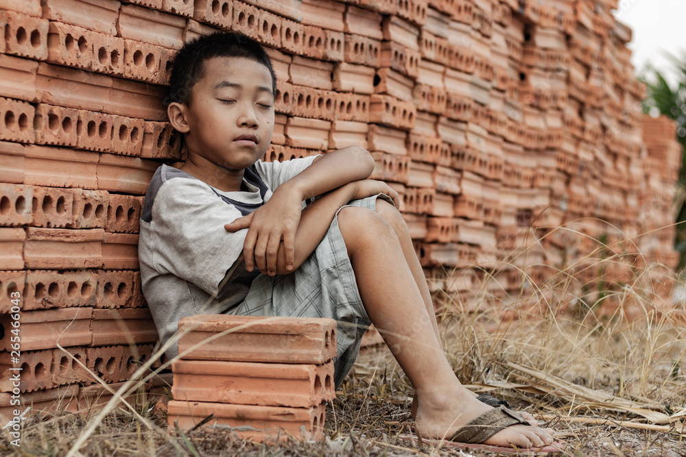 Child working in a brick factory. world day against child labor concept ...