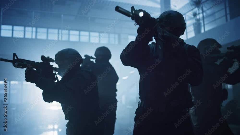 Masked Squad of Armed SWAT Police Officers Stand in Dark Seized Office Building with Desks and ...